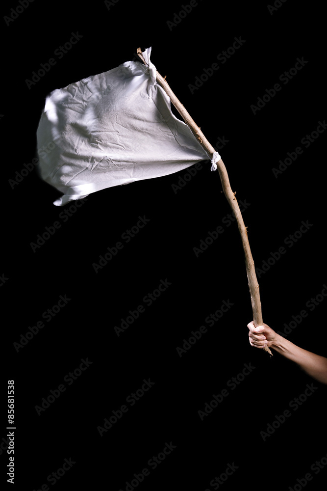 Hand holding white flag against black background Stock Photo | Adobe Stock