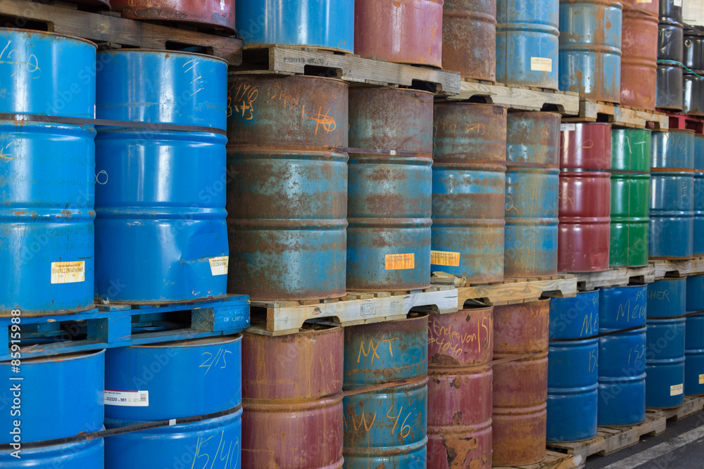 Rows of stacked steel barrels of various colors Stock Photo | Adobe Stock