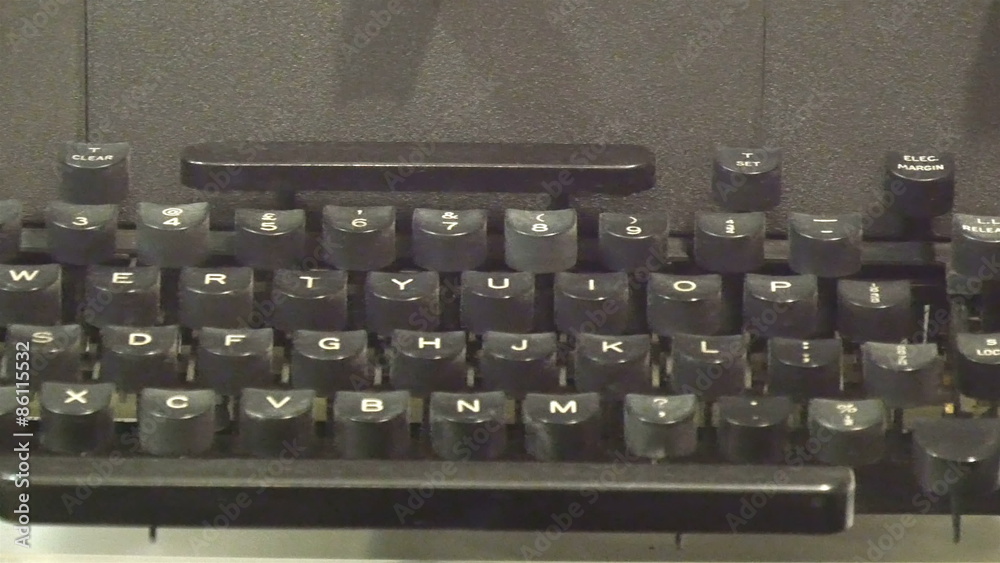 An old black model of a typewriter. With the big black keys with ...