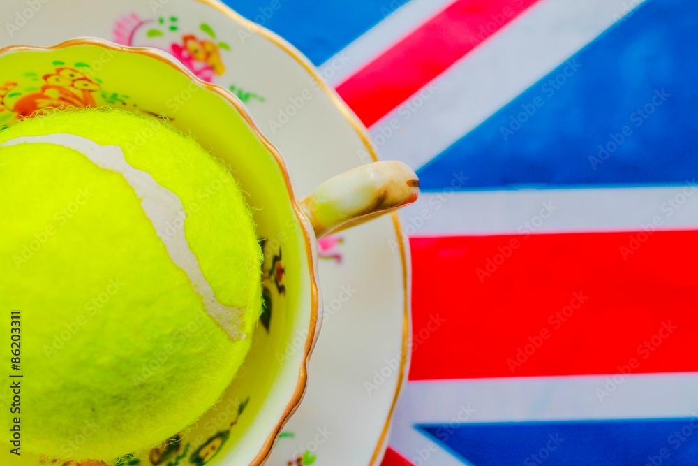 British Tennis - A cup and saucer with a tennis ball inside on top of ...