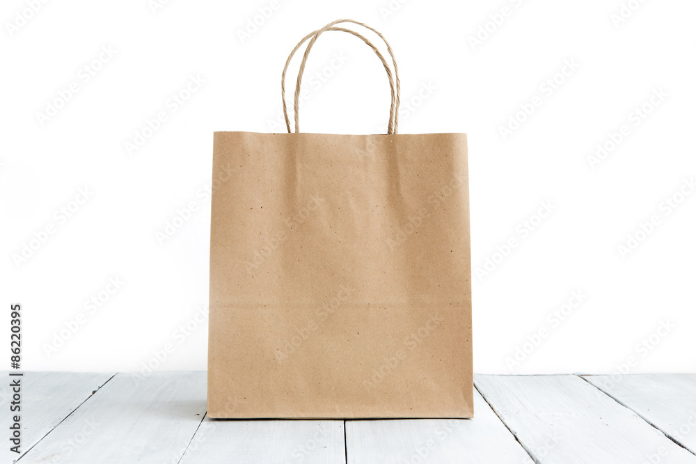 Paper bag on the wooden background Stock Photo | Adobe Stock