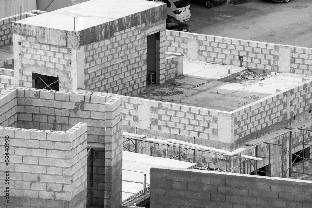 Black and white image of half built villas showing internal walls and ...