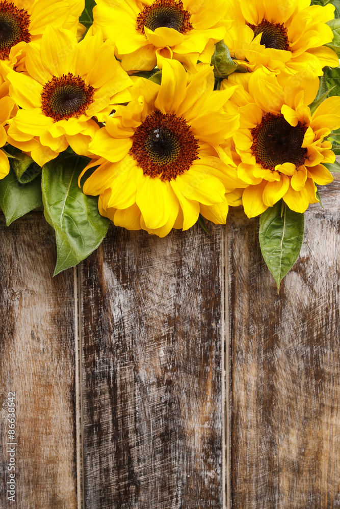 Sunflowers on wooden background Stock Photo | Adobe Stock