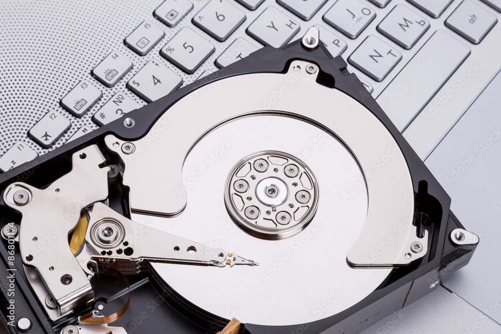 Hard disk HDD over laptop keyboard Stock Photo | Adobe Stock