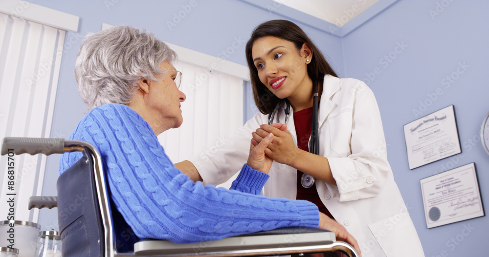 Mexican woman doctor comforting elderly patient Stock Photo | Adobe Stock