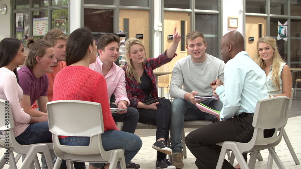 College Students With Tutor Having Discussion Stock Video | Adobe Stock