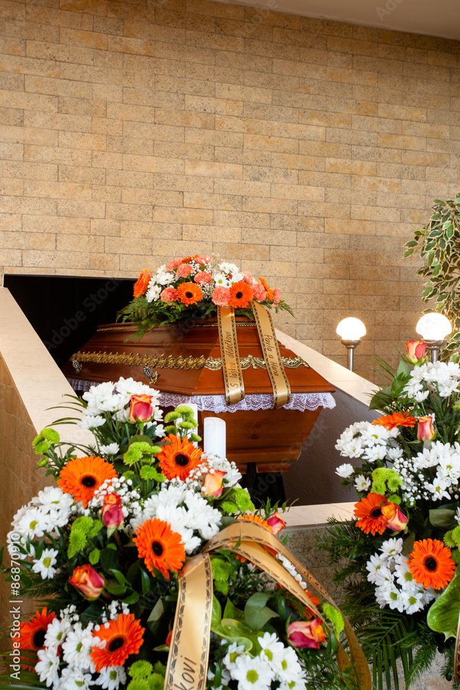 Funeral hall with wooden coffin and flower decoration, prepared for ...