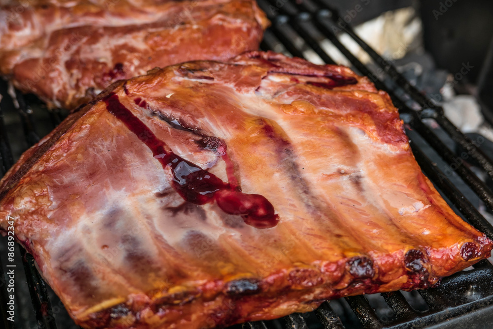 Pork Ribs on Grill. Charcoal outdoor BBQ grill with pork ribs cooking ...