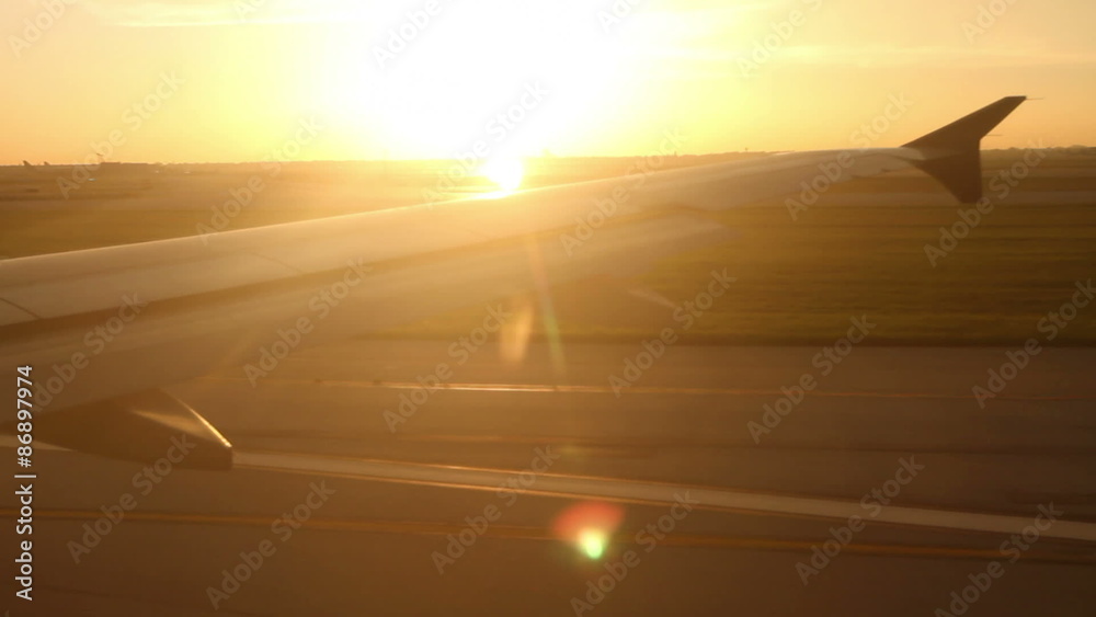 Plane Takeoff at Sunset – Looking out the window at the wing of a jet ...
