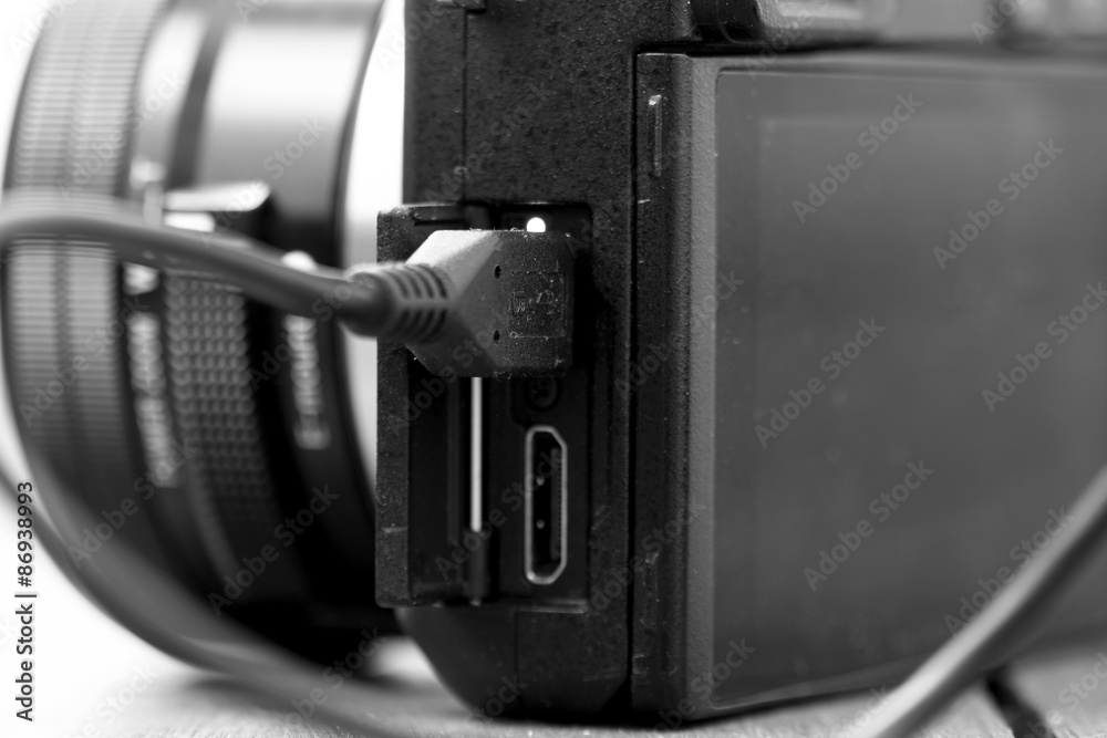 Camera charging. Camera lead plugged in and charging. Stock Photo ...