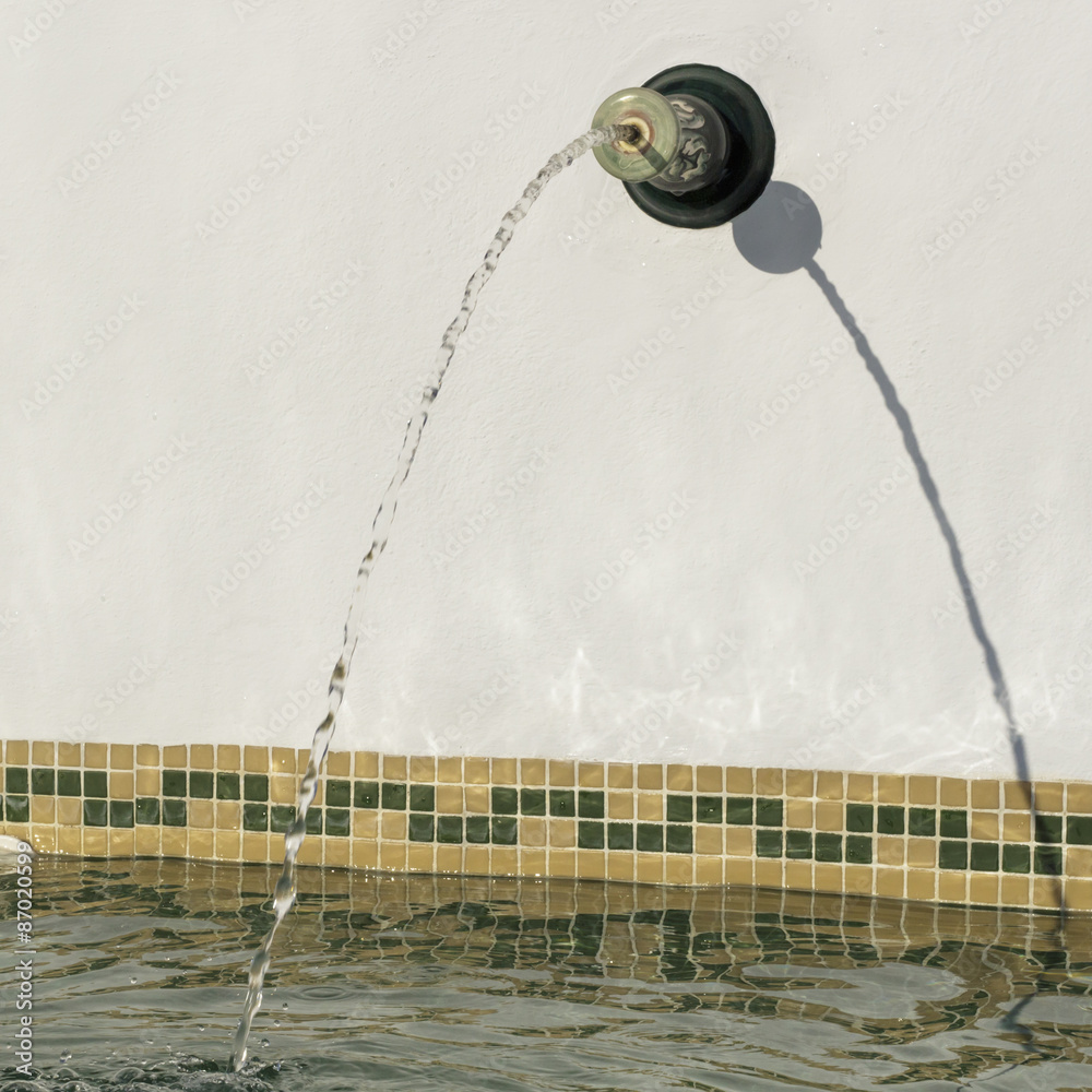 Water jet falling into a swimming pool Stock Photo | Adobe Stock