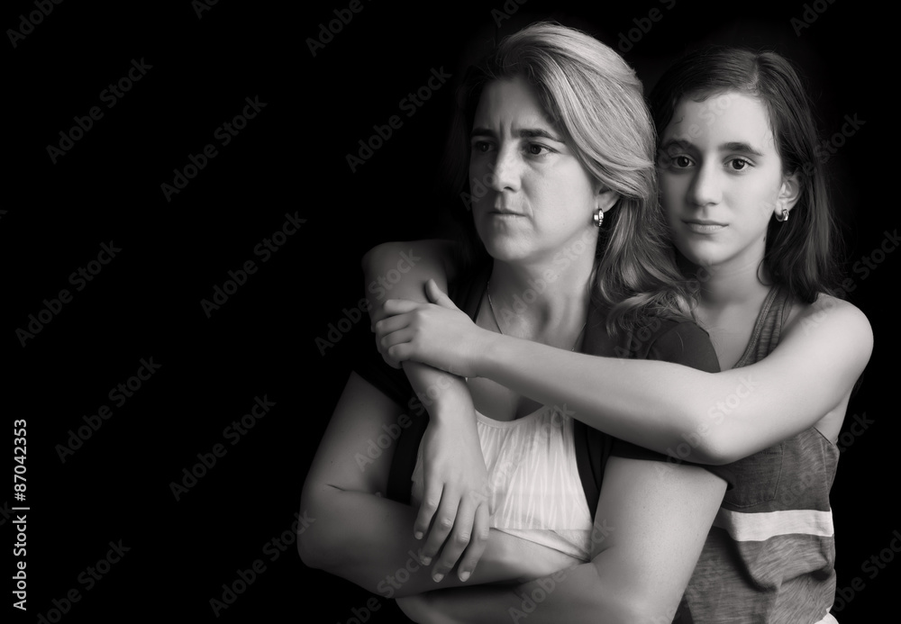 Sad and angry mother with daughter embracing her Stock Photo | Adobe Stock