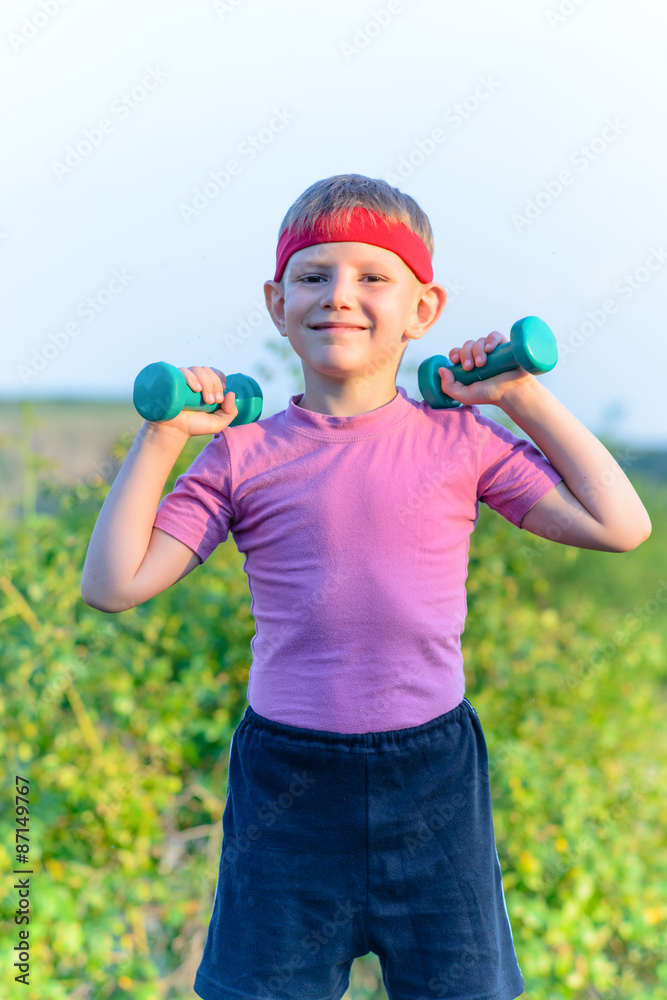 Strong Boy Lifting Two Small Dumbbells Stock Photo | Adobe Stock
