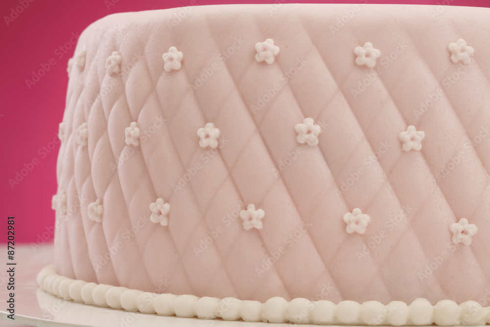 Decorative fondant pink cake on picnic table/ Pink background Stock ...