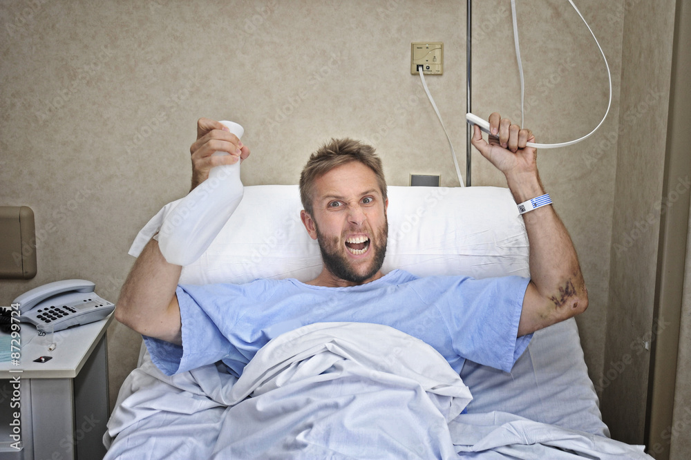 angry patient at hospital room in bed pressing nurse call button upset ...