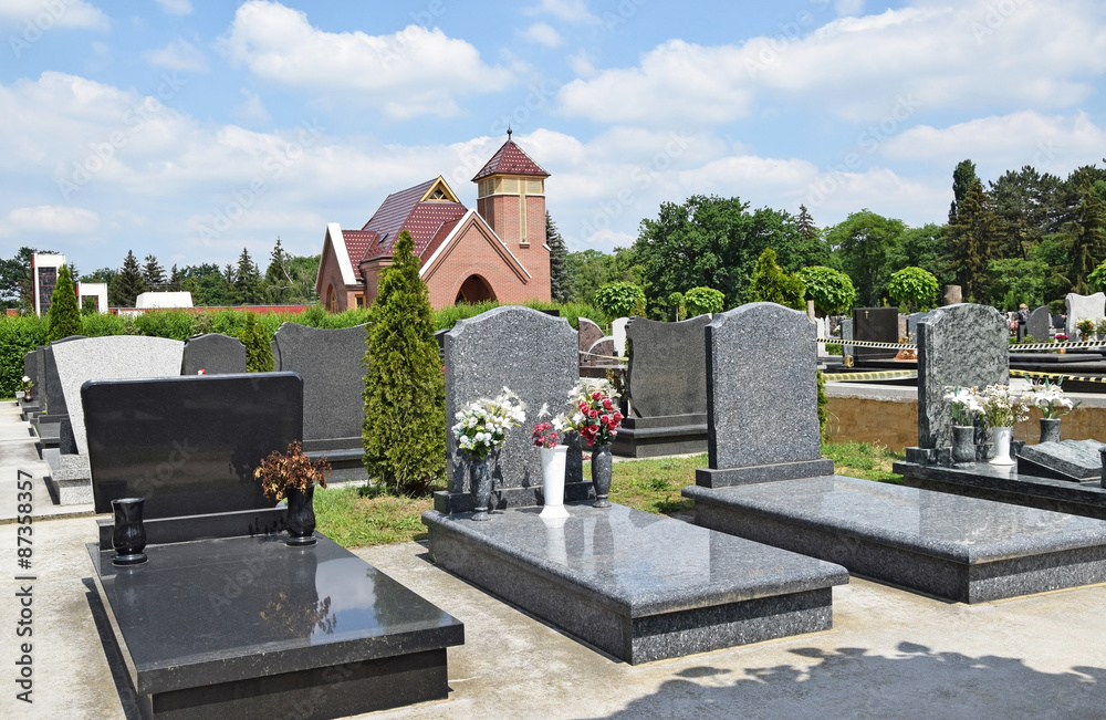 Tombstones and a chapel in the public cemetery Stock Photo | Adobe Stock