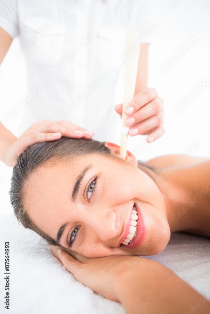 Beautiful Woman Receiving Ear Candle Treatment At Spa Center Stock