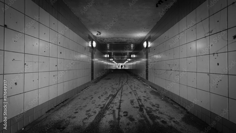 Pedestrian tunnel. An urban pedestrian underpass with graffiti and low ...