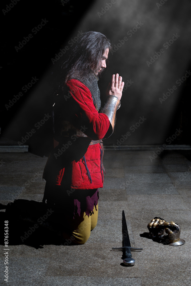 Side View of Knight Kneeling on His Knees Praying Before Battle Stock ...