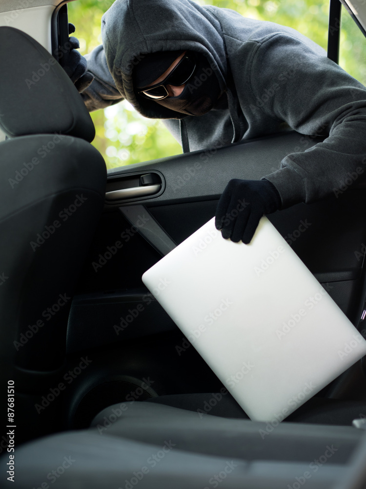 Car theft - a laptop being stolen through the window of an Stock Photo ...
