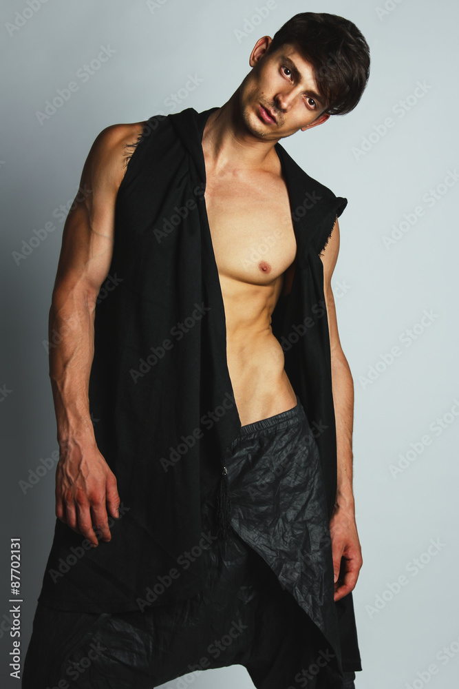 Urban street concept. Male model with perfect body posing over gray ...