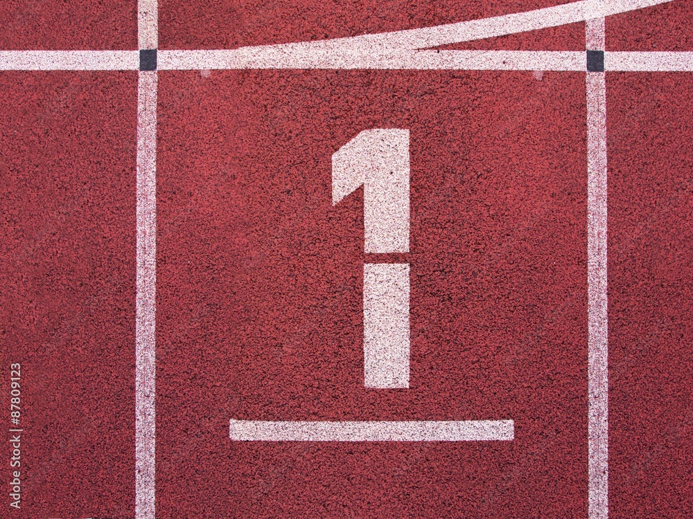 Number one. White track number on red rubber racetrack, texture of ...
