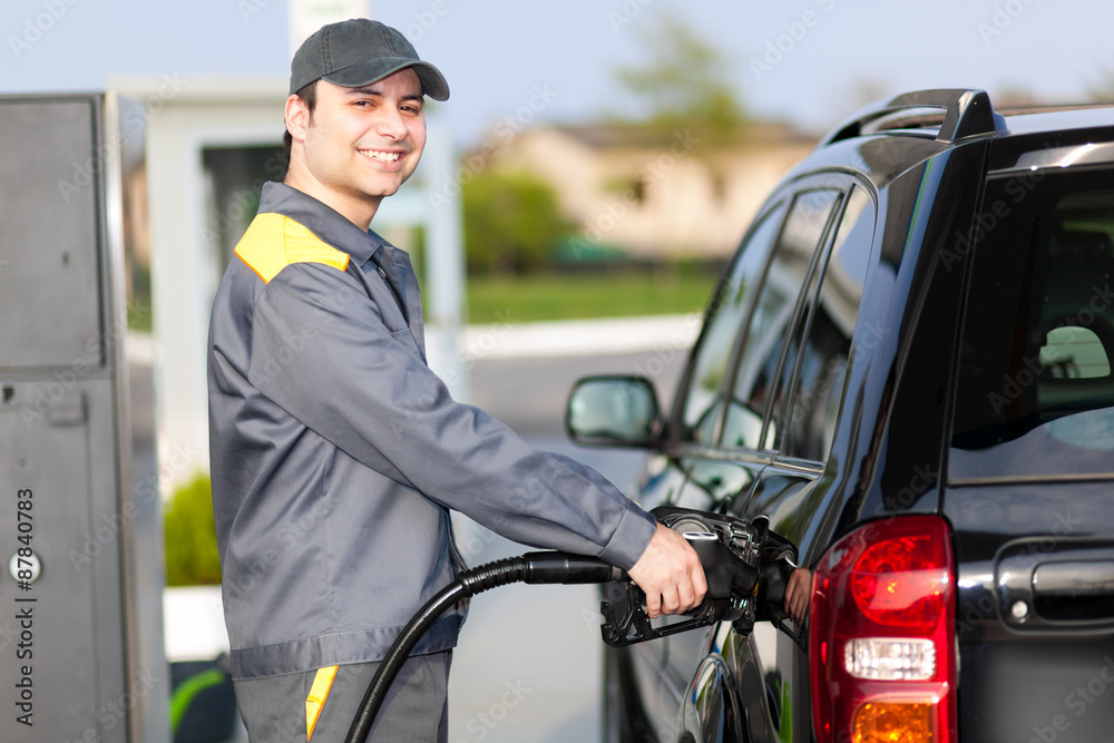 Foto Stock Gas station attendant at work | Adobe Stock