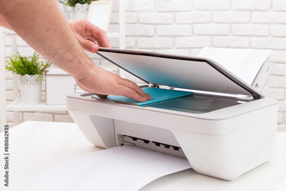 Man's hand working with printer Stock Photo | Adobe Stock