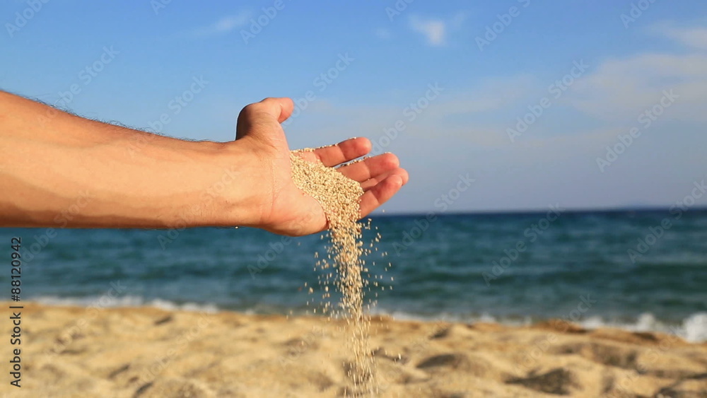 Man pouring sand from his hand at the beach Stock Video | Adobe Stock