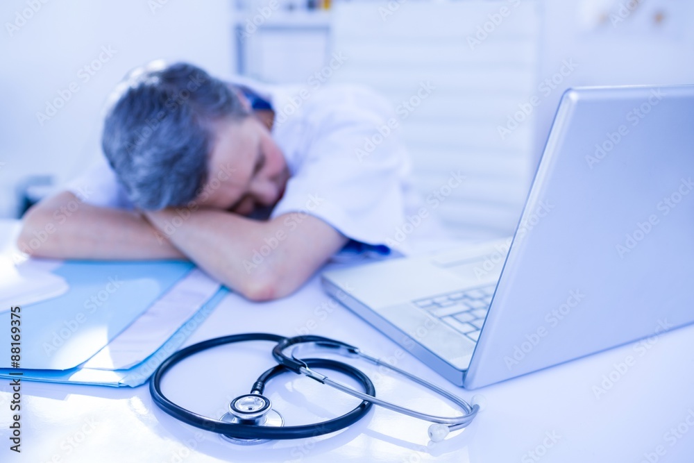 Female doctor sleeping on desk Stock Photo | Adobe Stock