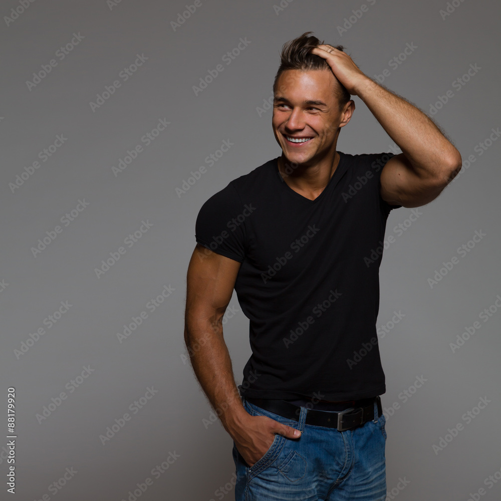 Man Combing The Hair With His Fingers. Smiling handsome man in black t ...