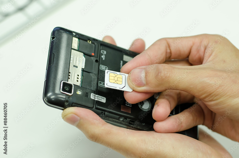 Inserting a sim card into the mobile phone Stock Photo | Adobe Stock