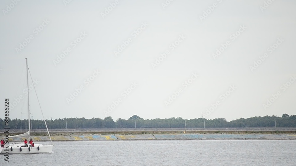 Modern motorized sail boat with lowered sail on Dnieper river Stock ...