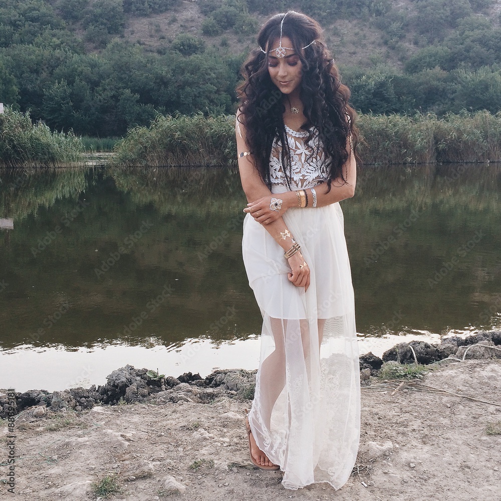 young beautiful woman dressed in boho style standing near lake Stock ...