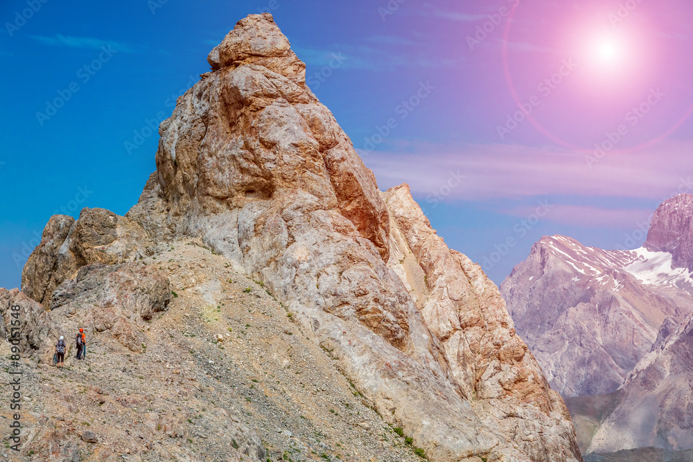Razor sharp summit and climbers Mountain landscape and blue sky with ...