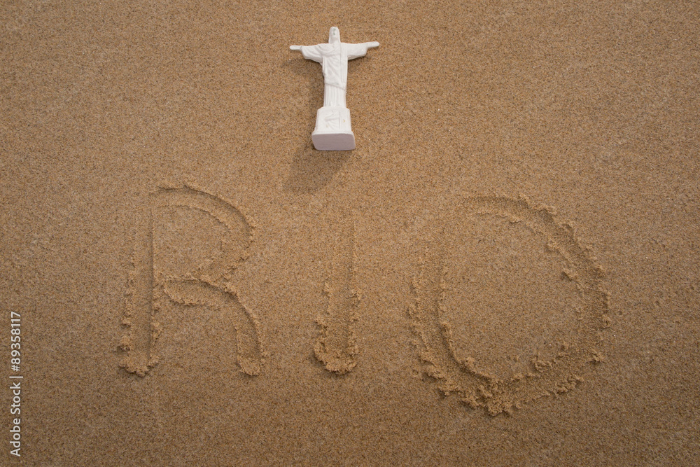 Simple Rio 2016 message handwritten in clean numbers on smooth sand ...