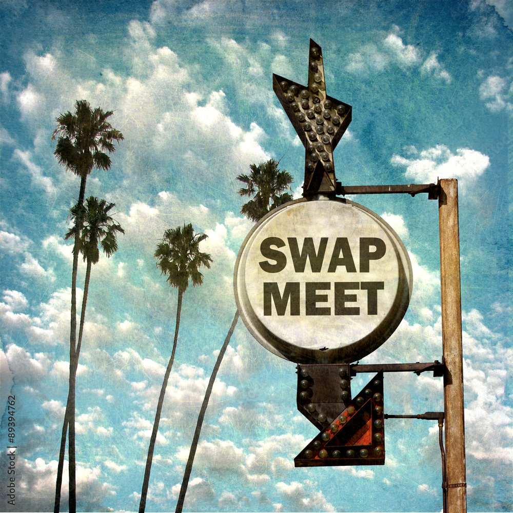 aged and worn vintage photo of swap meet sign with palm trees Stock ...