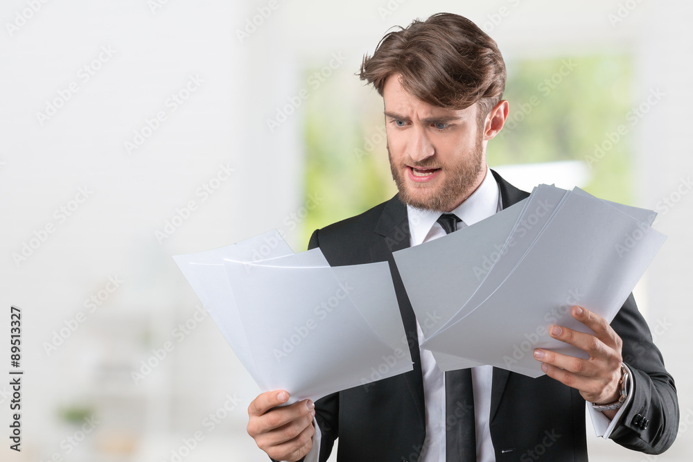 Businessman confused with a lot of paperwork Stock Photo | Adobe Stock