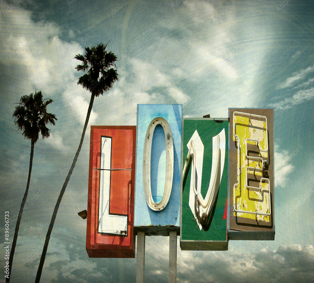 aged and worn vintage photo of neon love sign with palm trees Stock ...