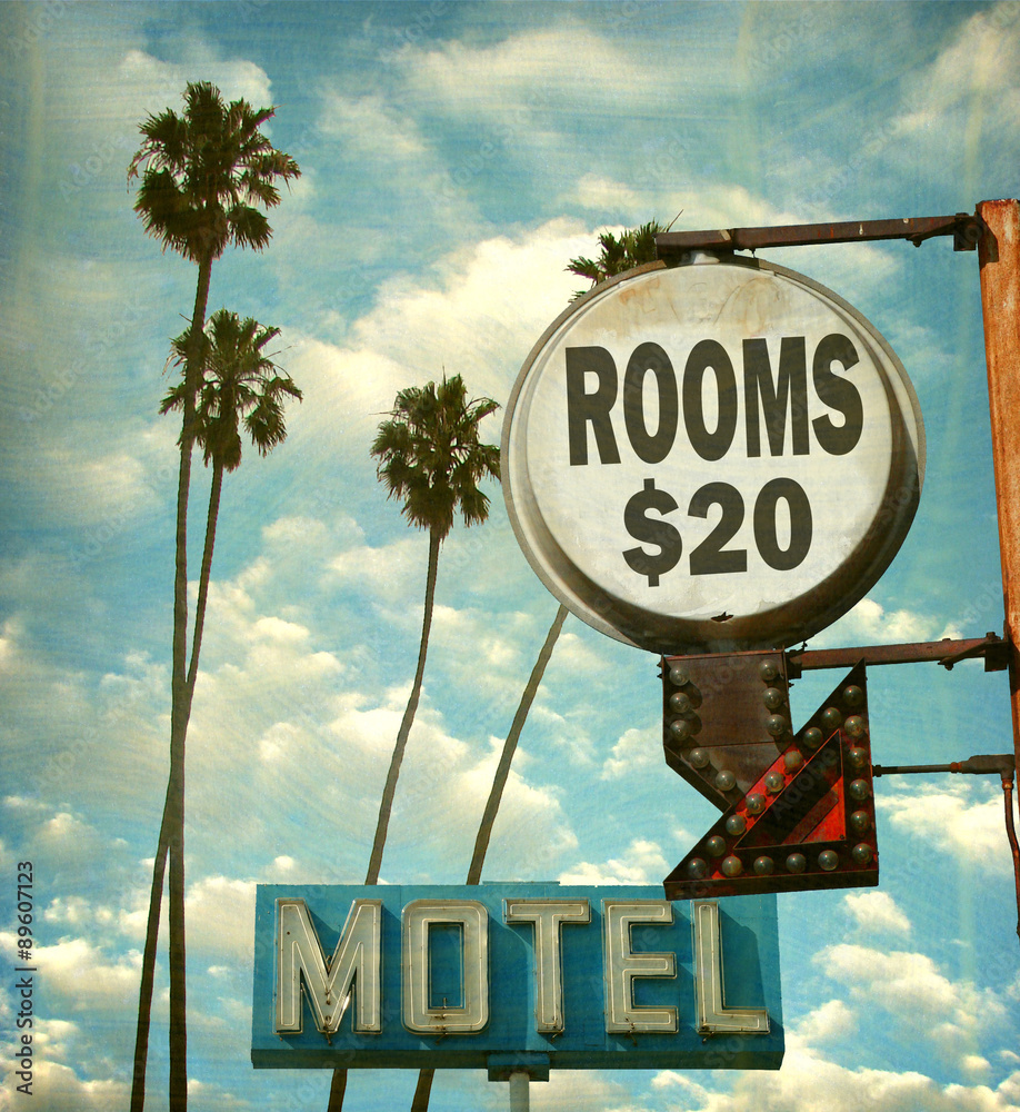 aged and worn vintage photo of motel rooms sign with palm trees Stock ...
