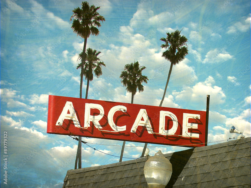 aged and worn vintage photo of neon arcade sign with palm trees Stock ...