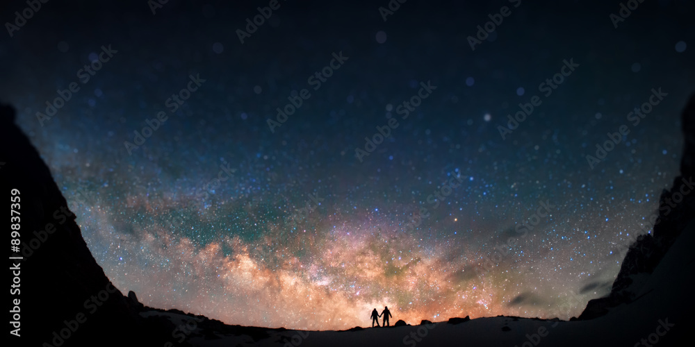Universe for two. Two people are standing together holding hands ...