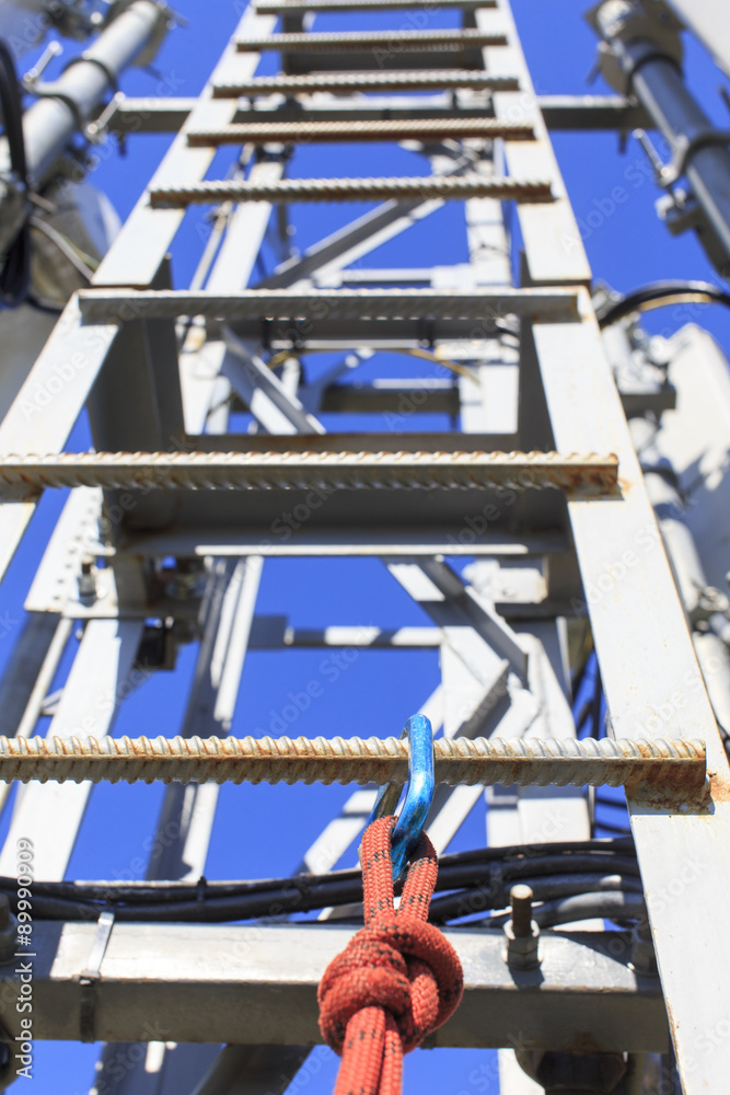 safety climber. carabiner with rope insures the climber on the ladder ...