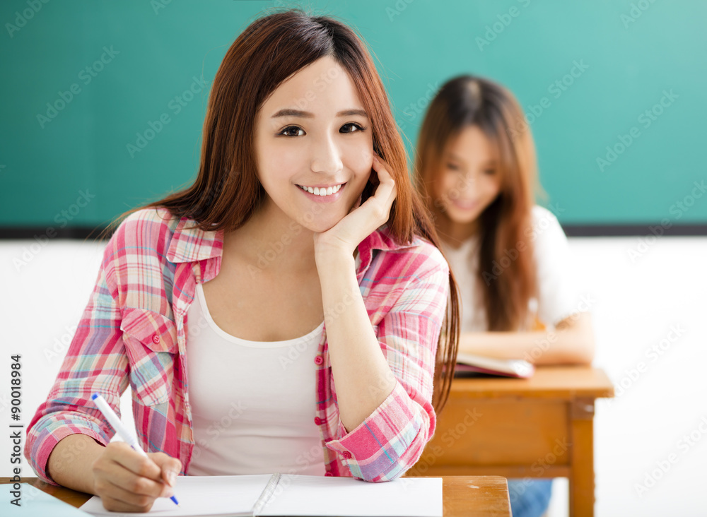 smiling Young student with others in the classroom Stock Photo | Adobe ...