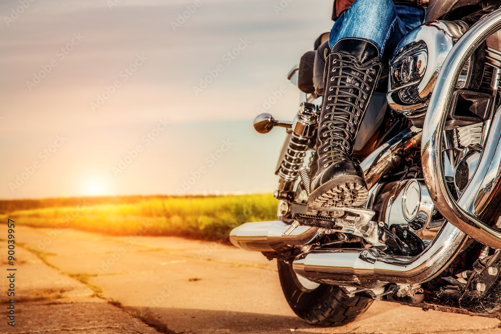 Biker girl riding on a motorcycle Stock Photo | Adobe Stock