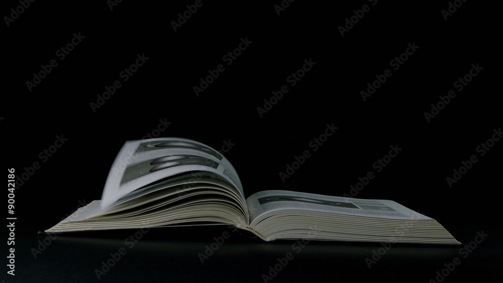 book page turning on black background 4k footage Stock Video | Adobe Stock