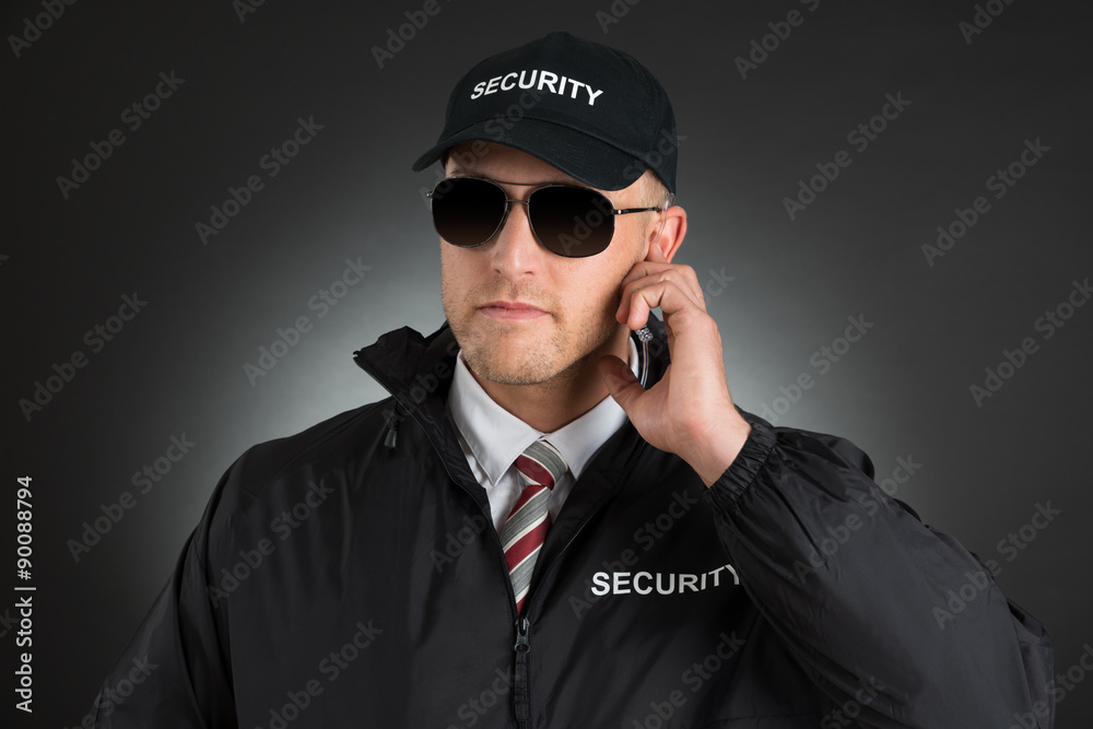 Secret Agent Listening To Earpiece foto de Stock | Adobe Stock