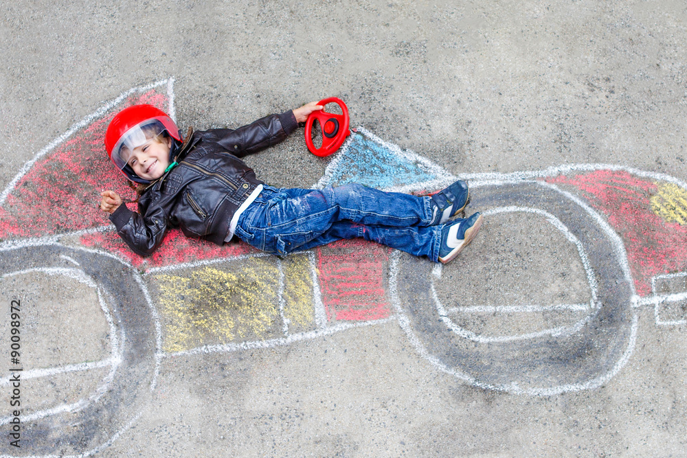 Little boy having fun with race car drawing with chalks Stock Photo ...