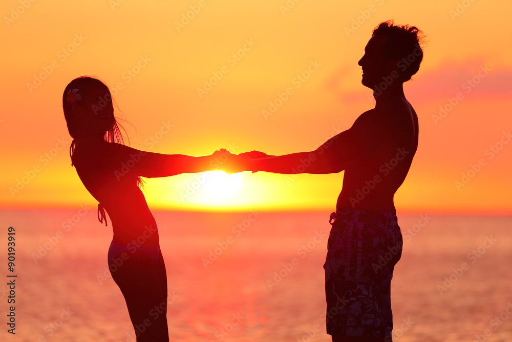 Two People Holding Hands In The Sunset