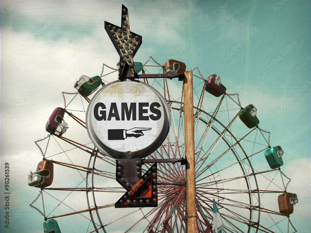 aged and worn vintage photo of games sign with ferris wheel Stock Photo ...